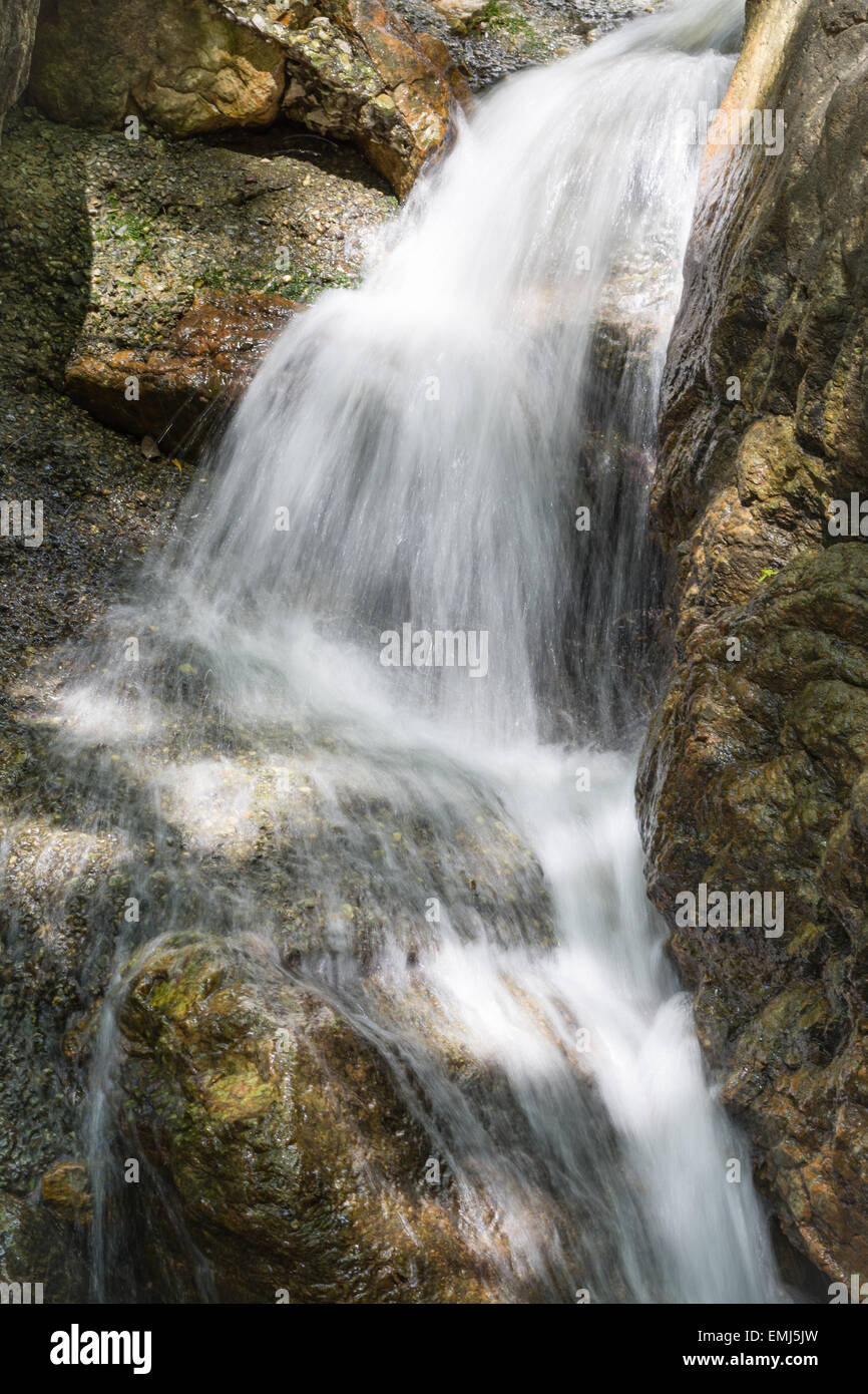 A waterfall running over and bouncing off of rocks Stock Photo - Alamy