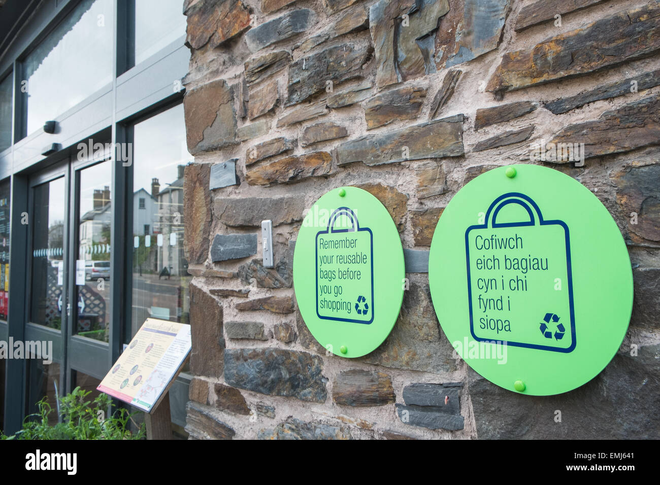 Outside Co-op store signs in English and Welsh encouraging customers to ...