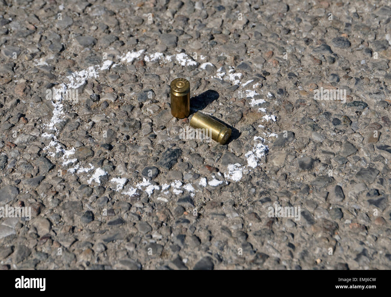 Bullets on ground with chalk drawn around Stock Photo - Alamy