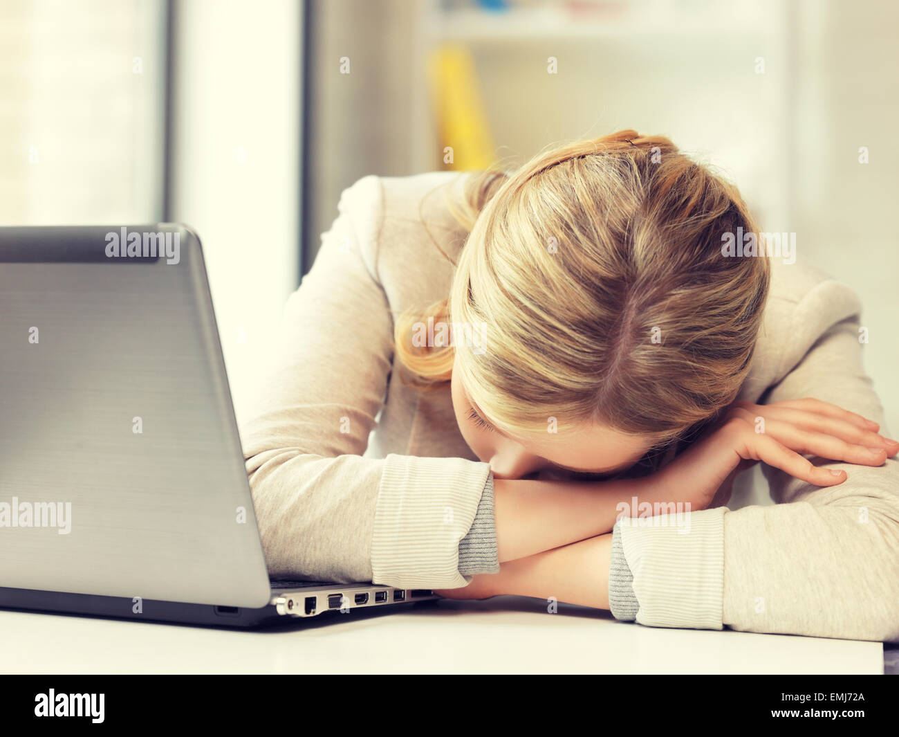 tired woman with laptop computer Stock Photo - Alamy