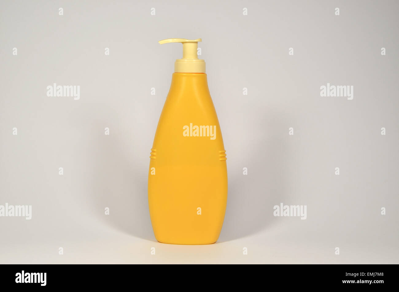 Yellow-orange color plastic unlabeled container with pump (half empty ...