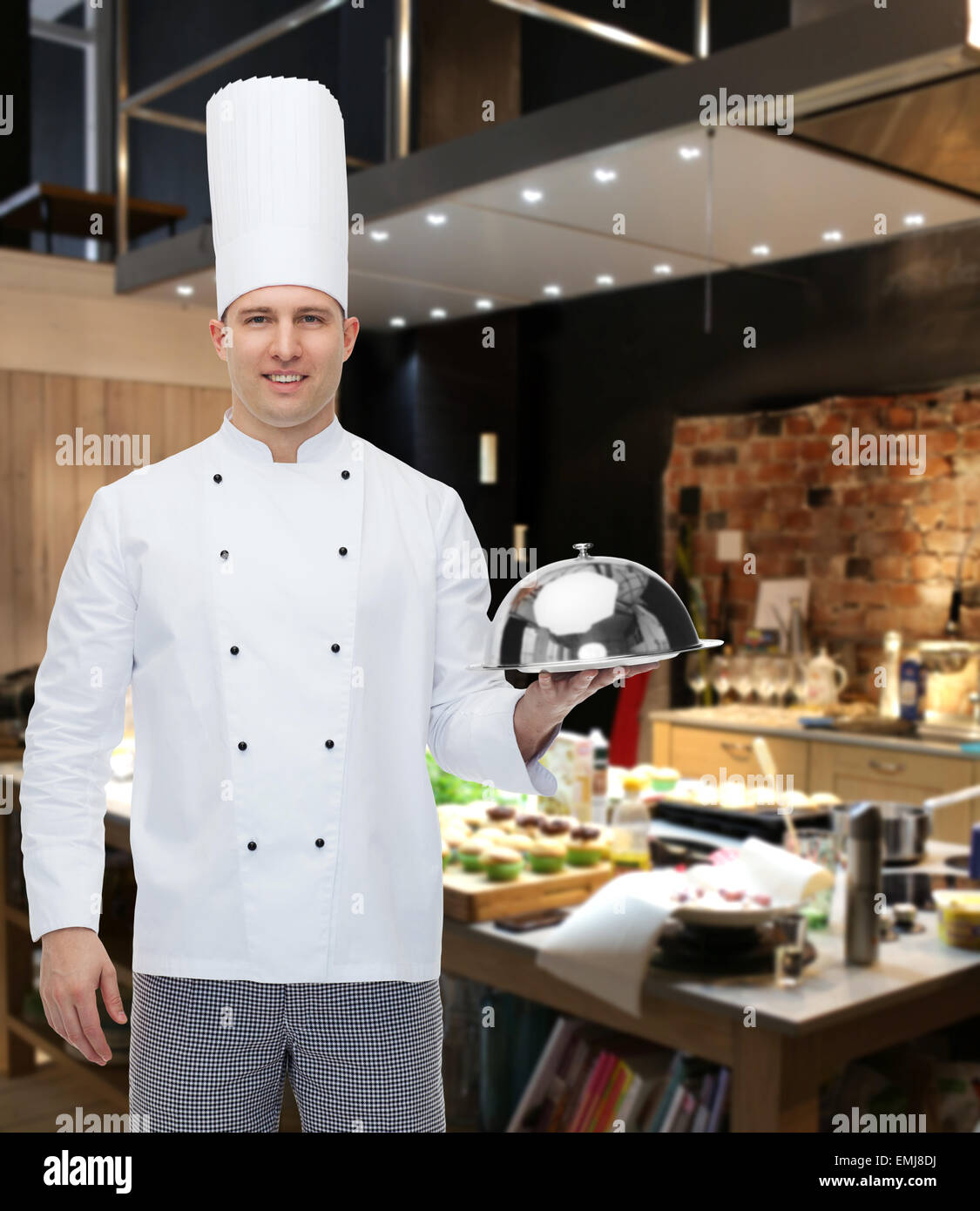 happy male chef cook holding cloche Stock Photo - Alamy