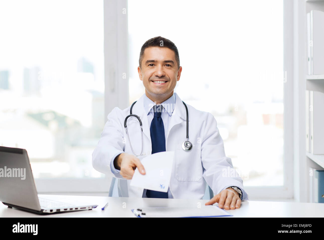 happy doctor with prescription and laptop Stock Photo - Alamy
