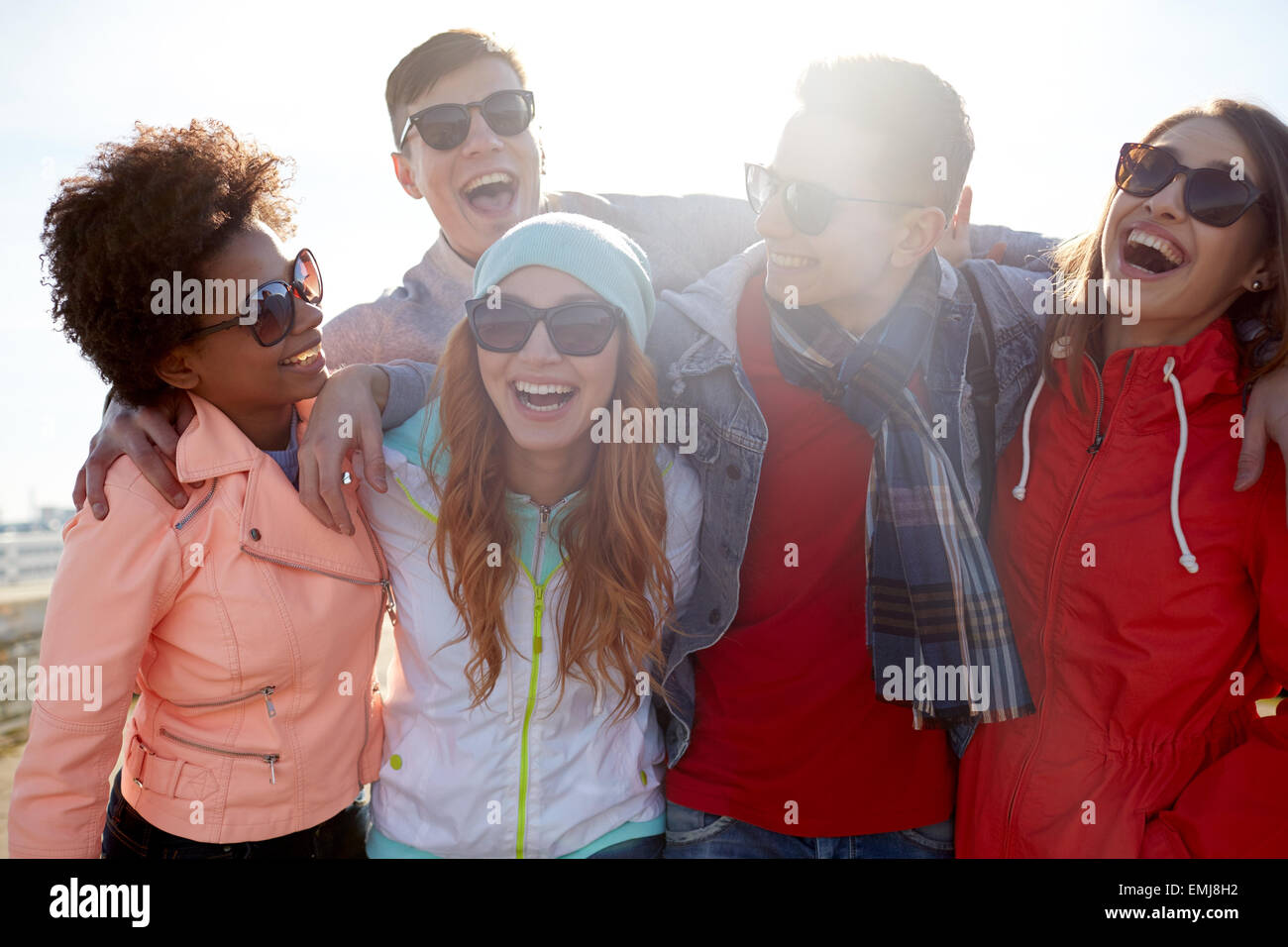 smiling friends in sunglasses laughing on street Stock Photo - Alamy