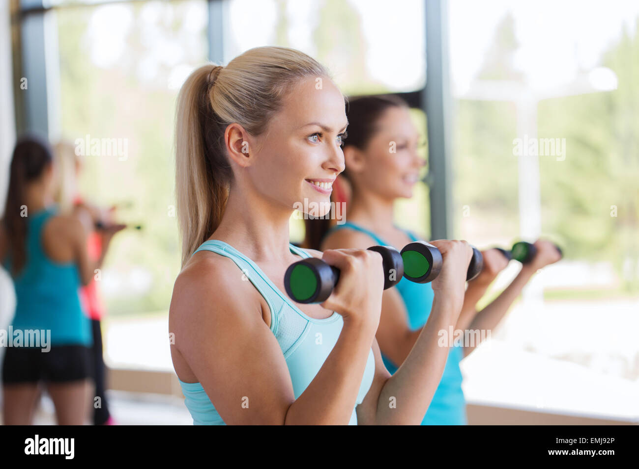group of women exercising with dumbbells in gym Stock Photo - Alamy