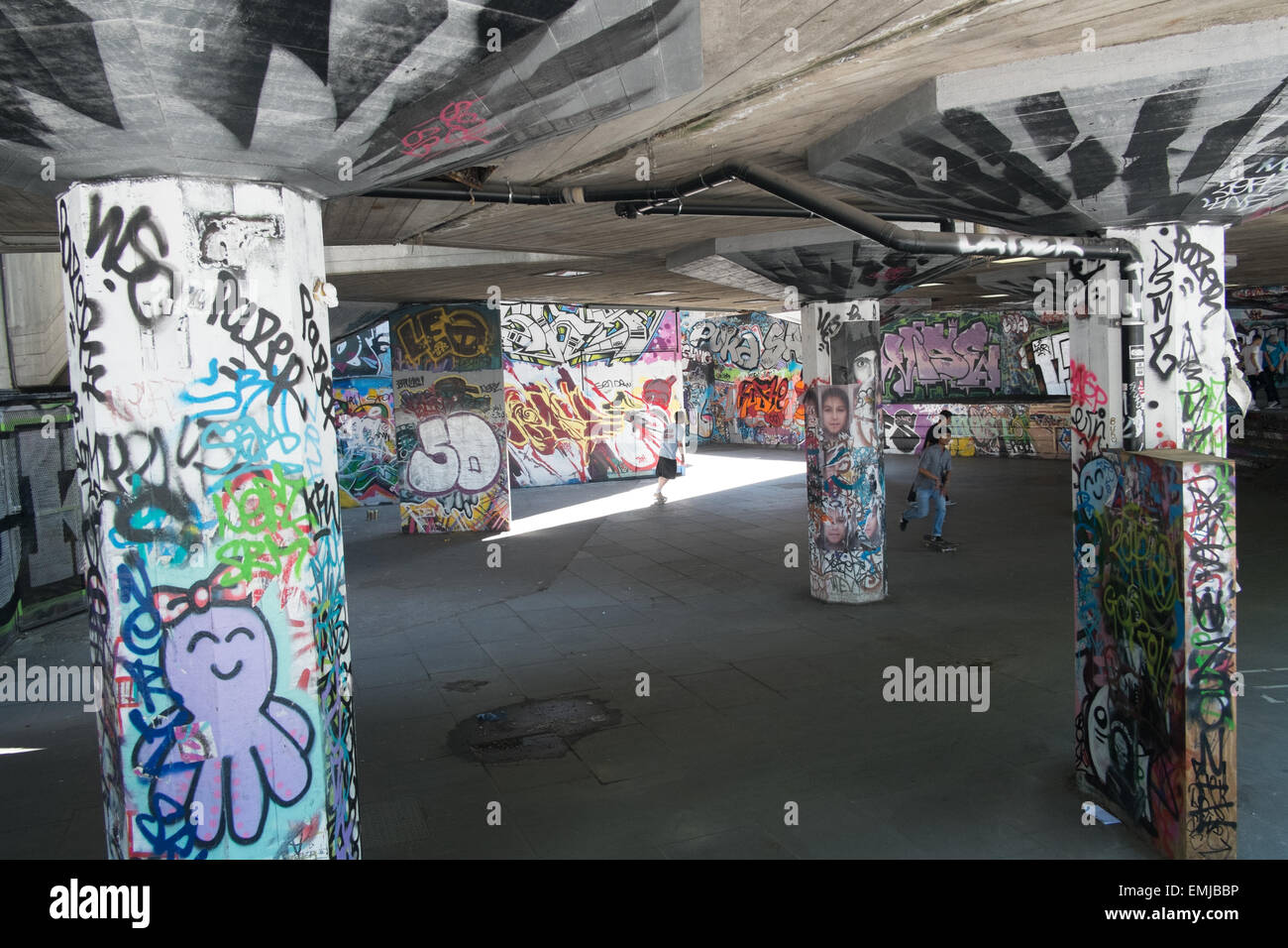 People running in a graffiti ridden overpass Stock Photo - Alamy