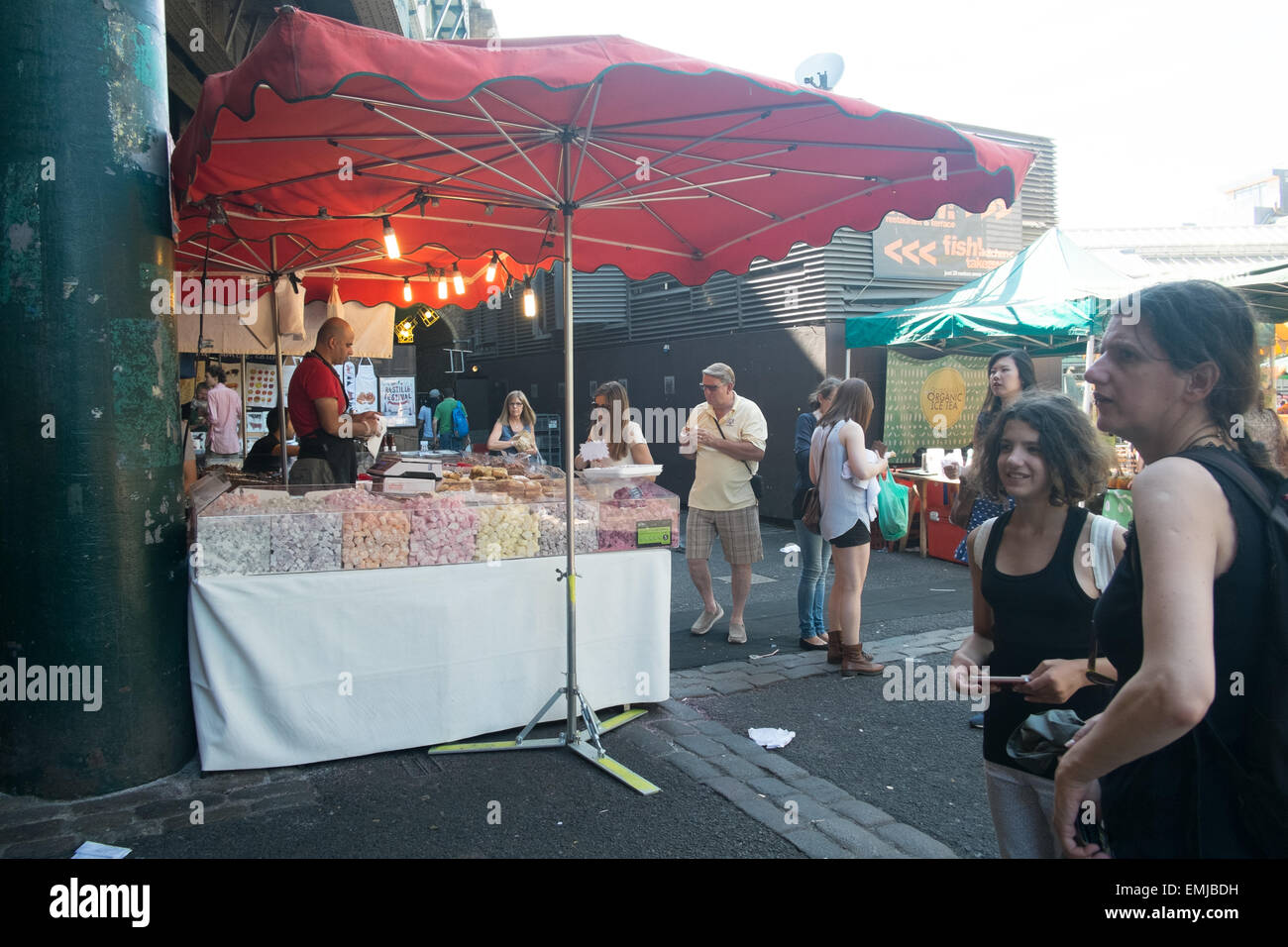 People at a market with a bead stall in the background Stock Photo - Alamy