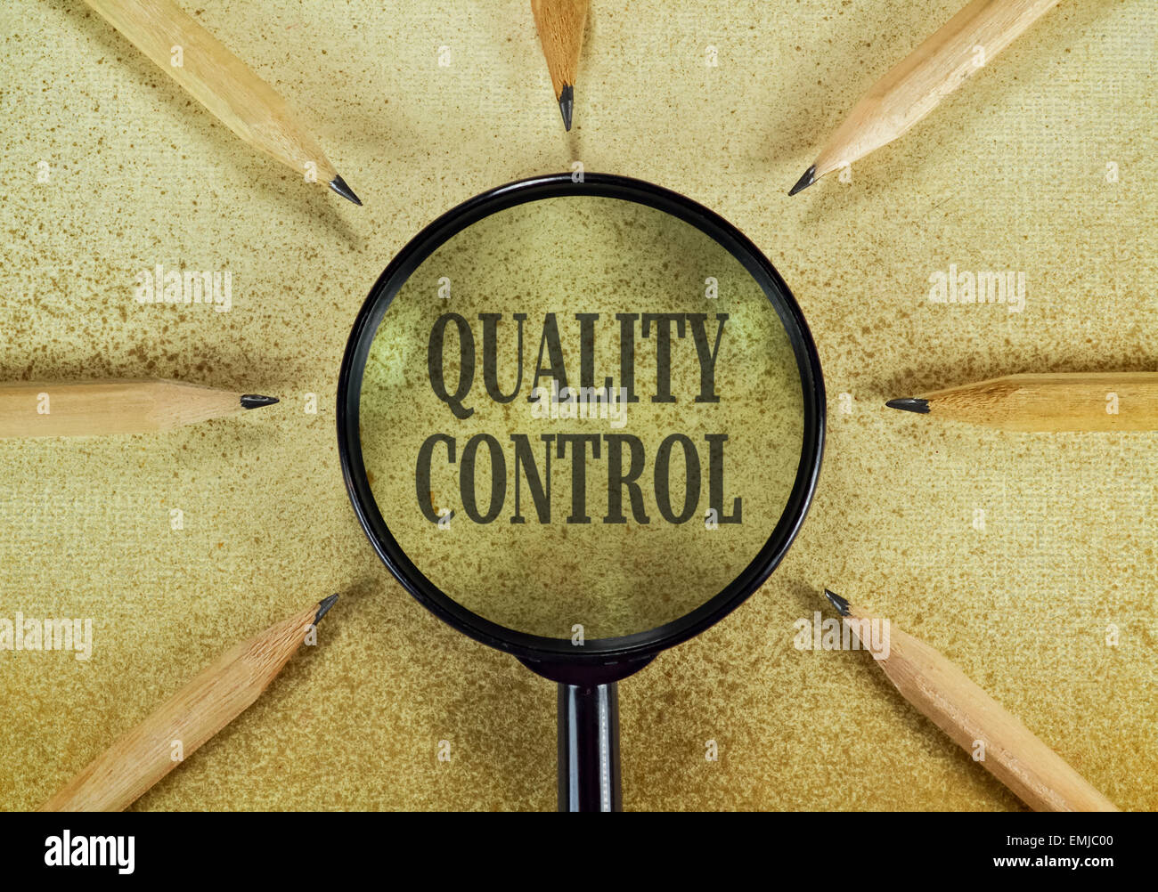 Pencils and magnifier in a conceptual image about controlling the ...