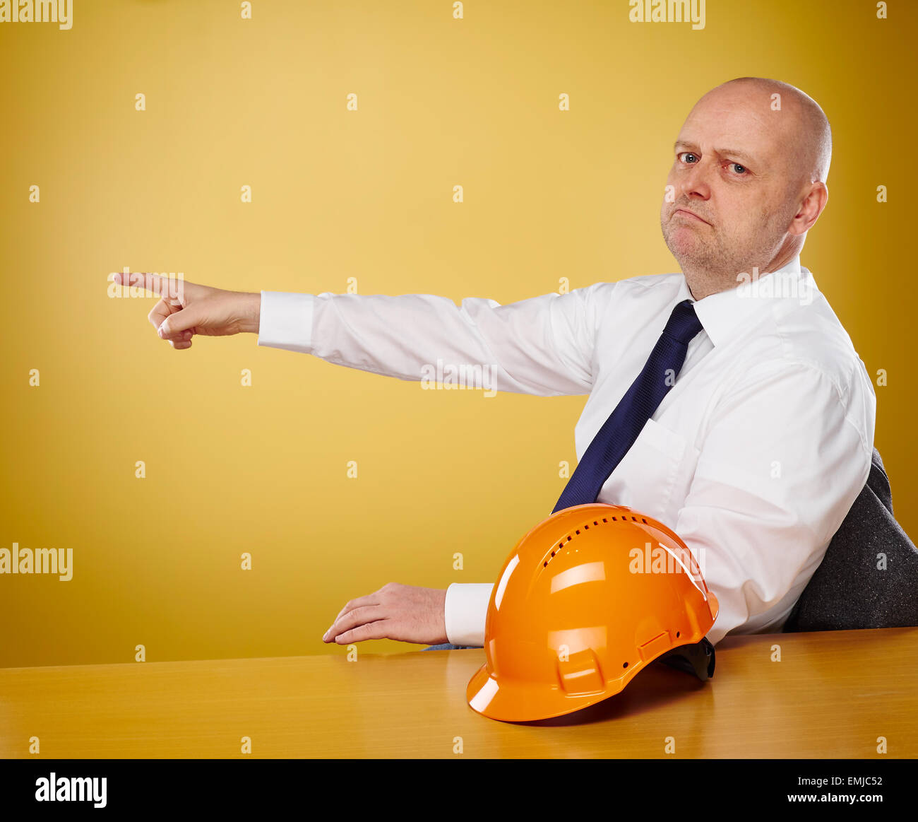 Male engineer in office, he wearing a white shirt and tie, the orange ...
