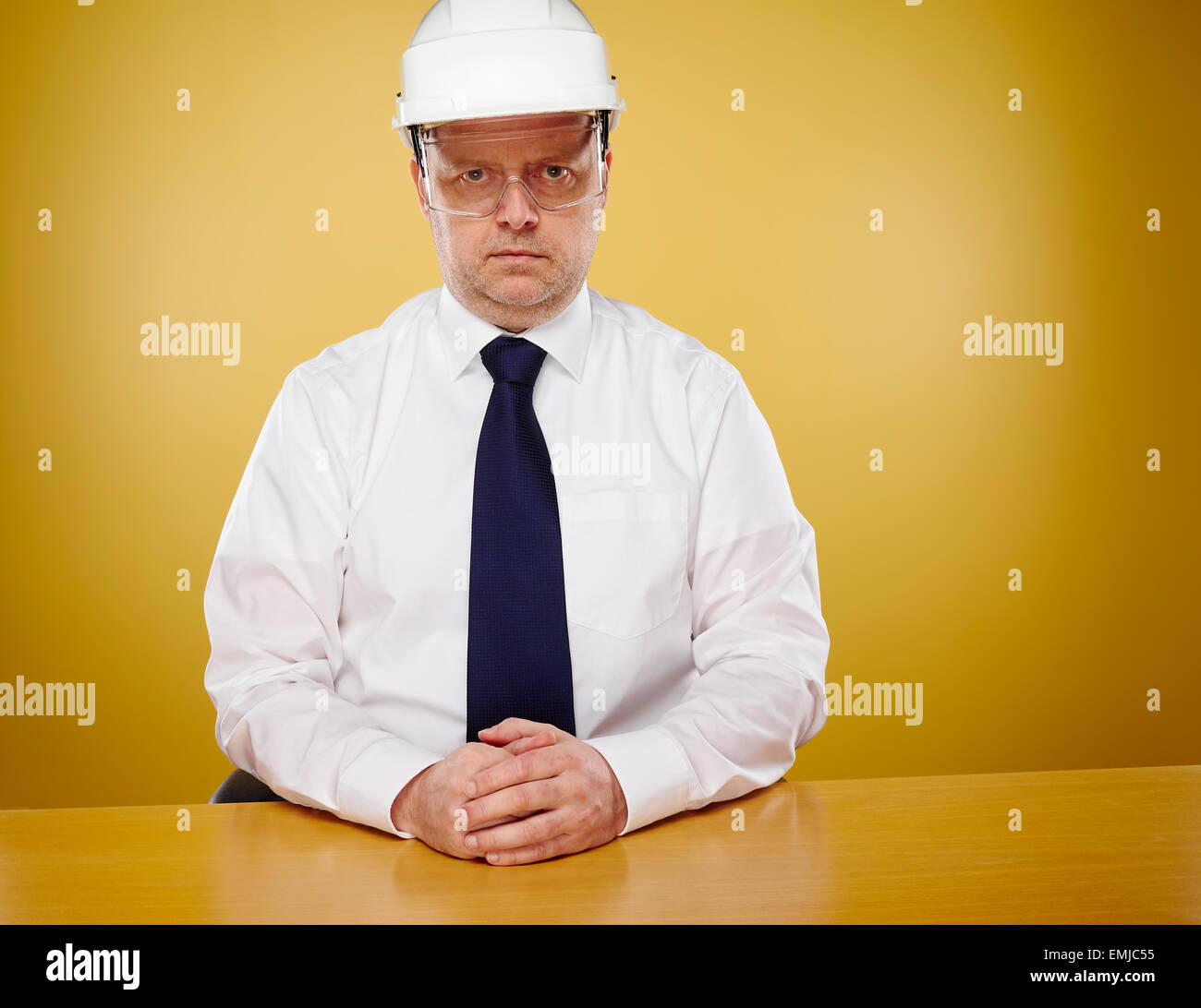 Serious male engineer in office and he looks toward the camera, he ...