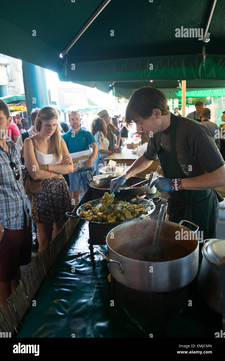 Serving food at a stall Stock Photo - Alamy