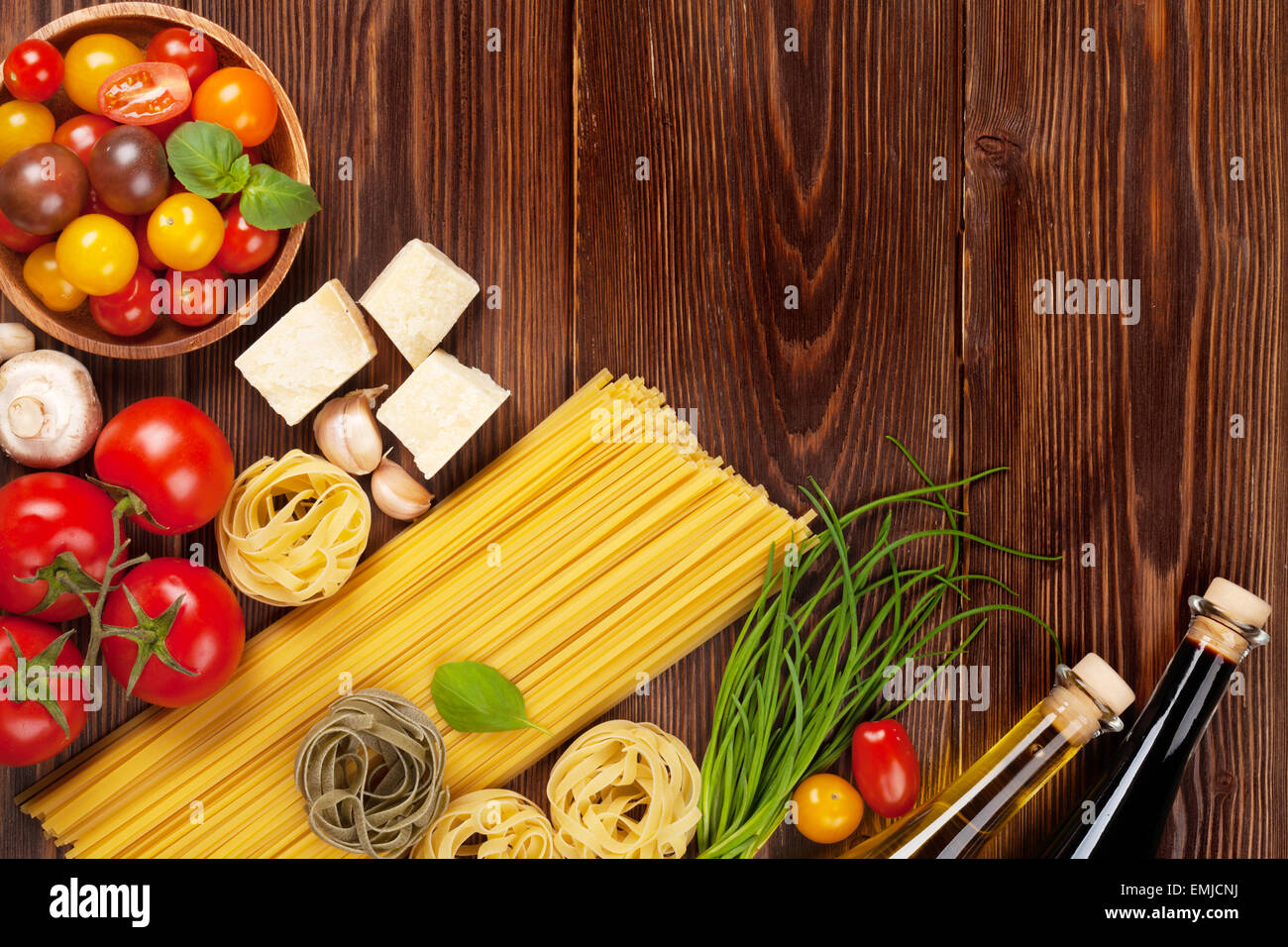 Italian food cooking ingredients. Pasta, tomatoes, basil. Top view with ...