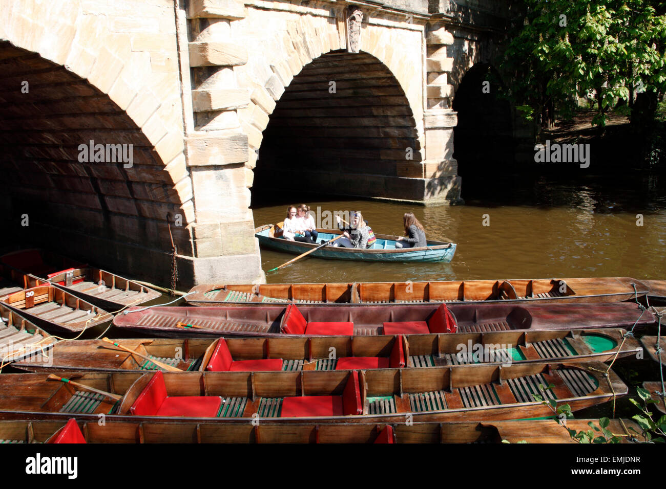 A rowing boat and punts on the river Cherwell at Magdalen bridge in the ...
