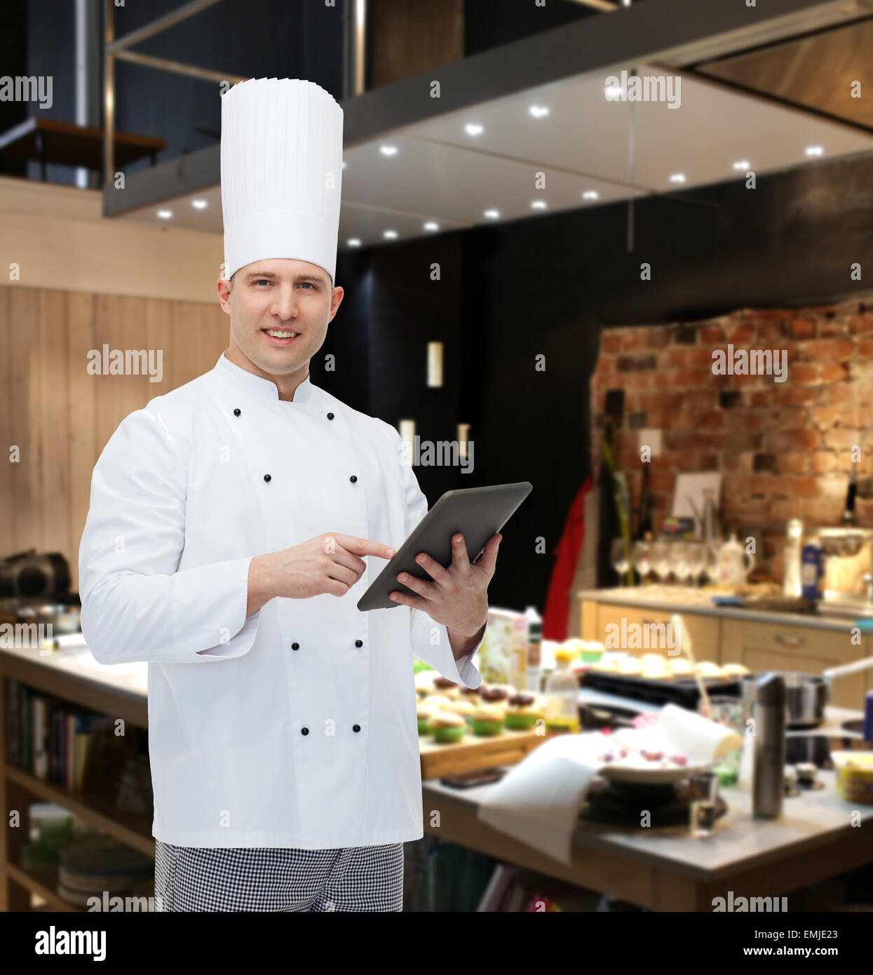 happy male chef cook holding tablet pc Stock Photo - Alamy