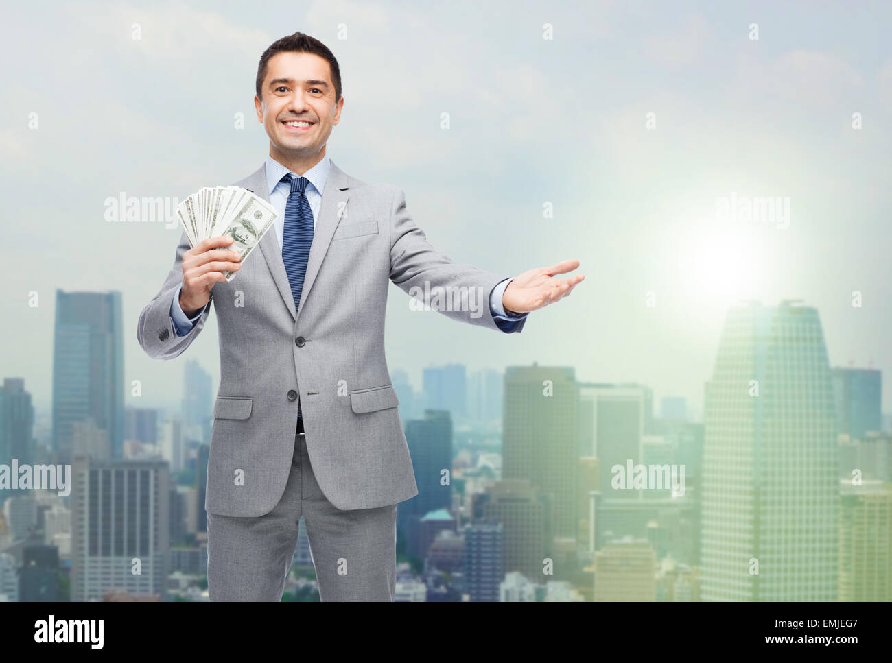 Successful businessman giving money hi-res stock photography and images ...