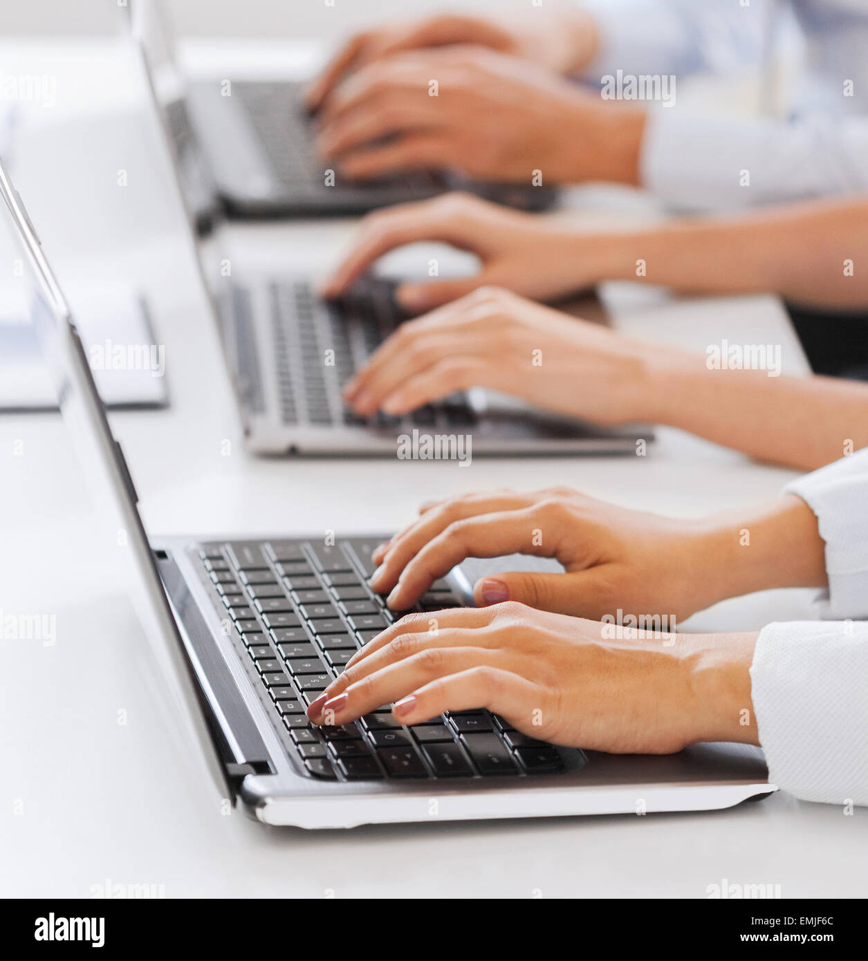 group of people working with laptops in office Stock Photo - Alamy