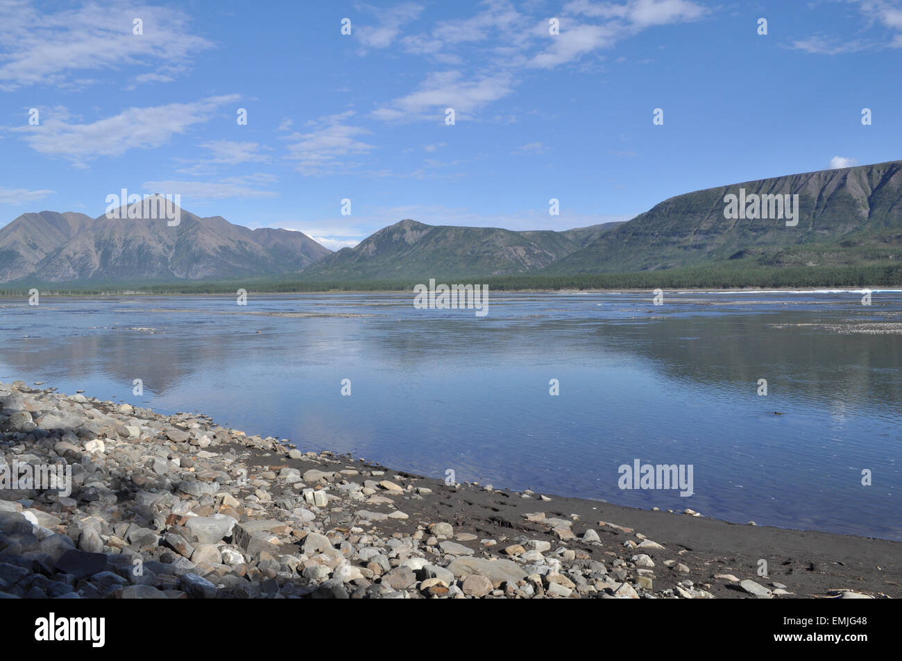 Sunny landscape of the river in the mountains. Russia, Yakutia ...