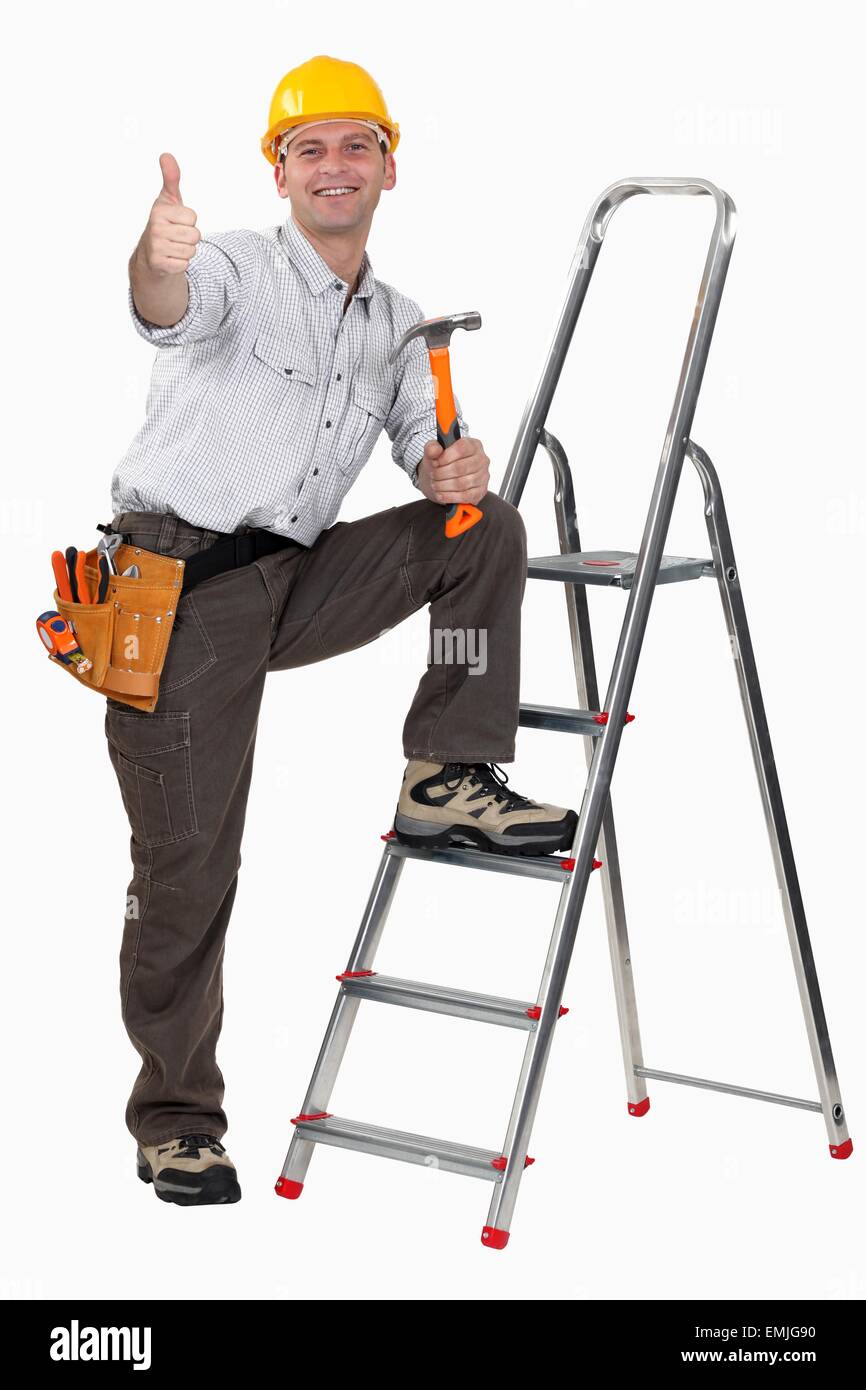 Handyman stood by ladder giving the thumbs-up Stock Photo - Alamy