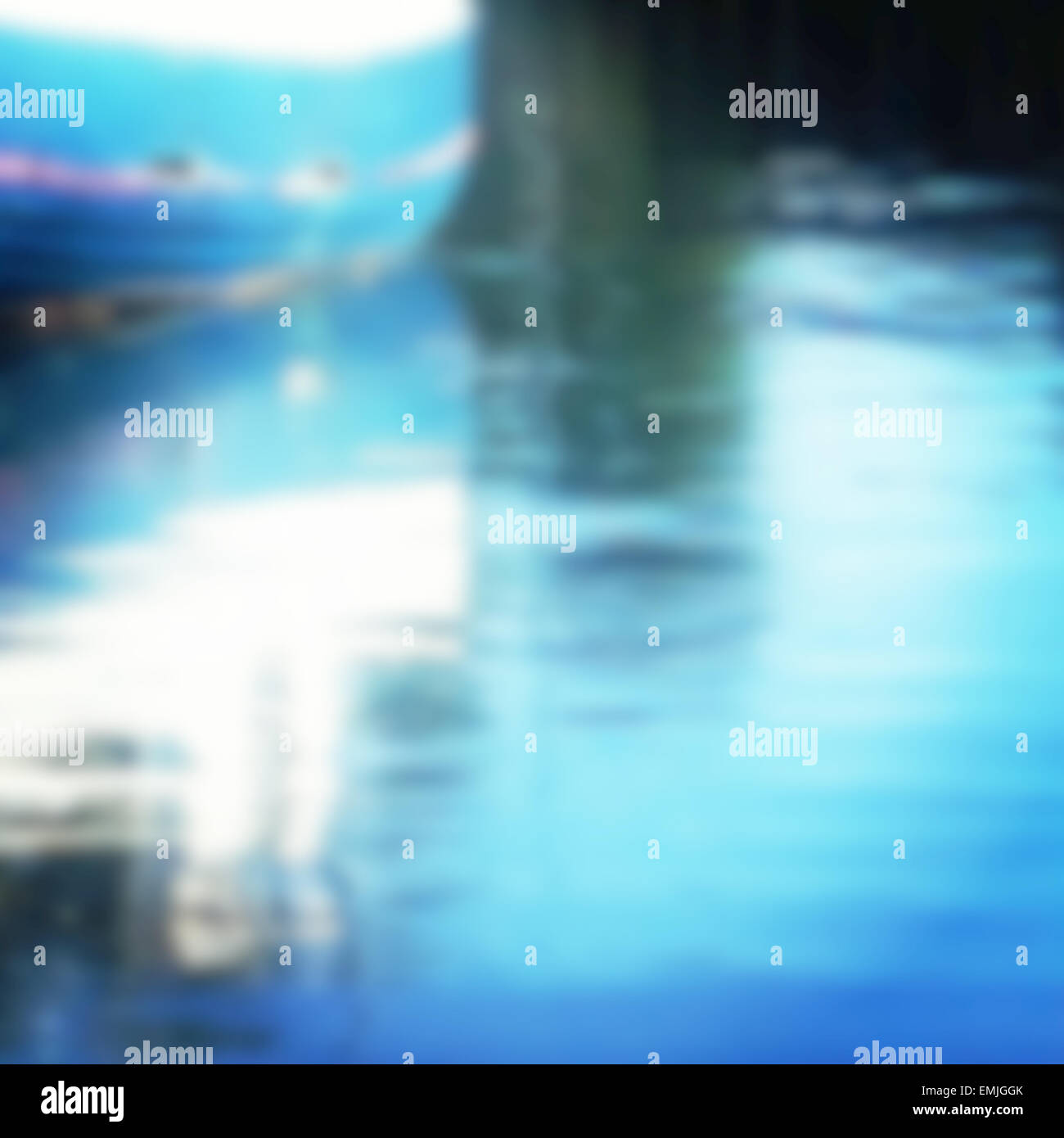 Defocused blue boat reflecting in blue water Stock Photo - Alamy