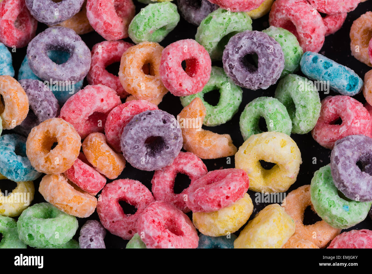 Vivid colorful O cereal against black background Stock Photo - Alamy