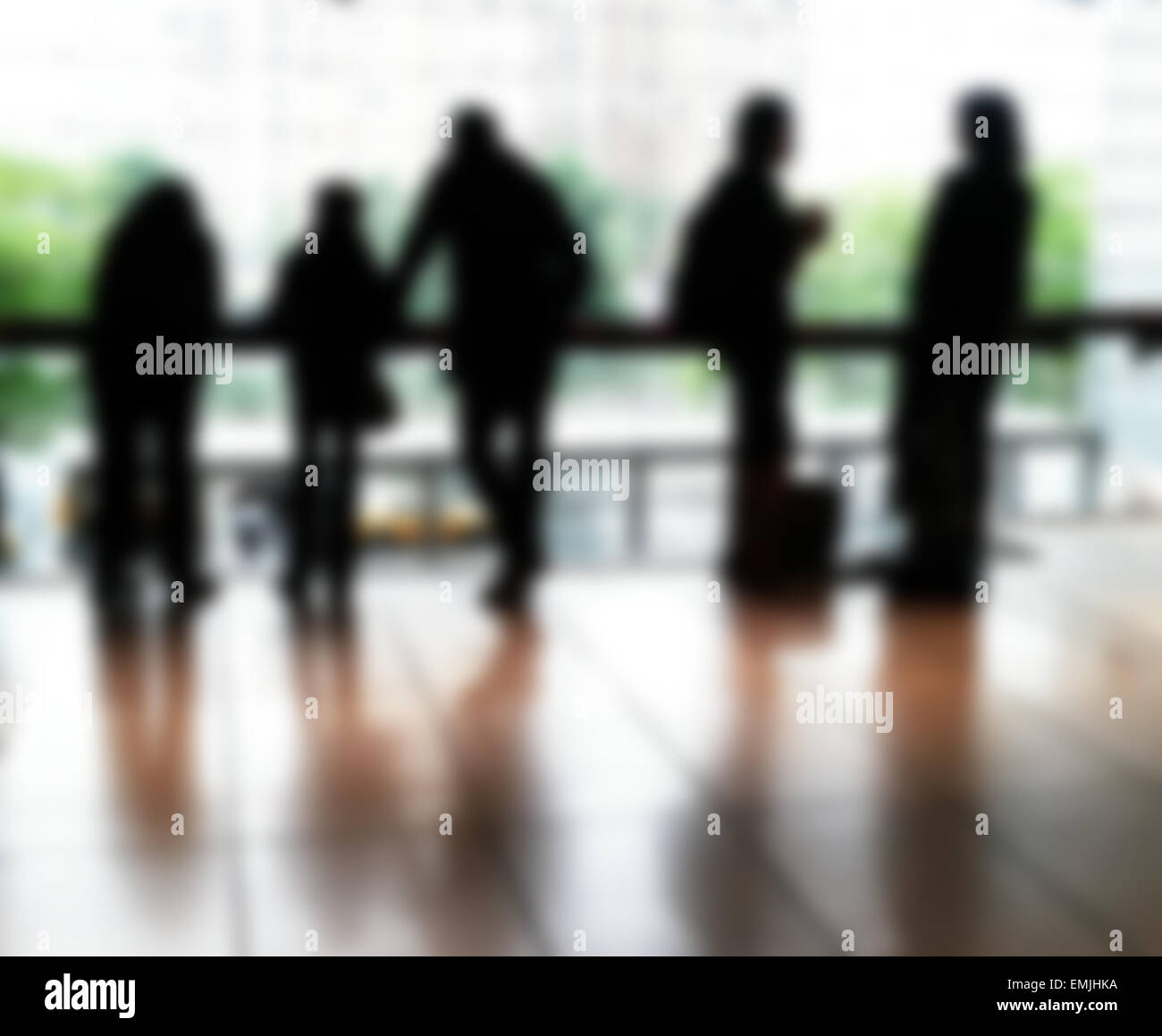 Silhouette of five de-focused people standing in different poses ...