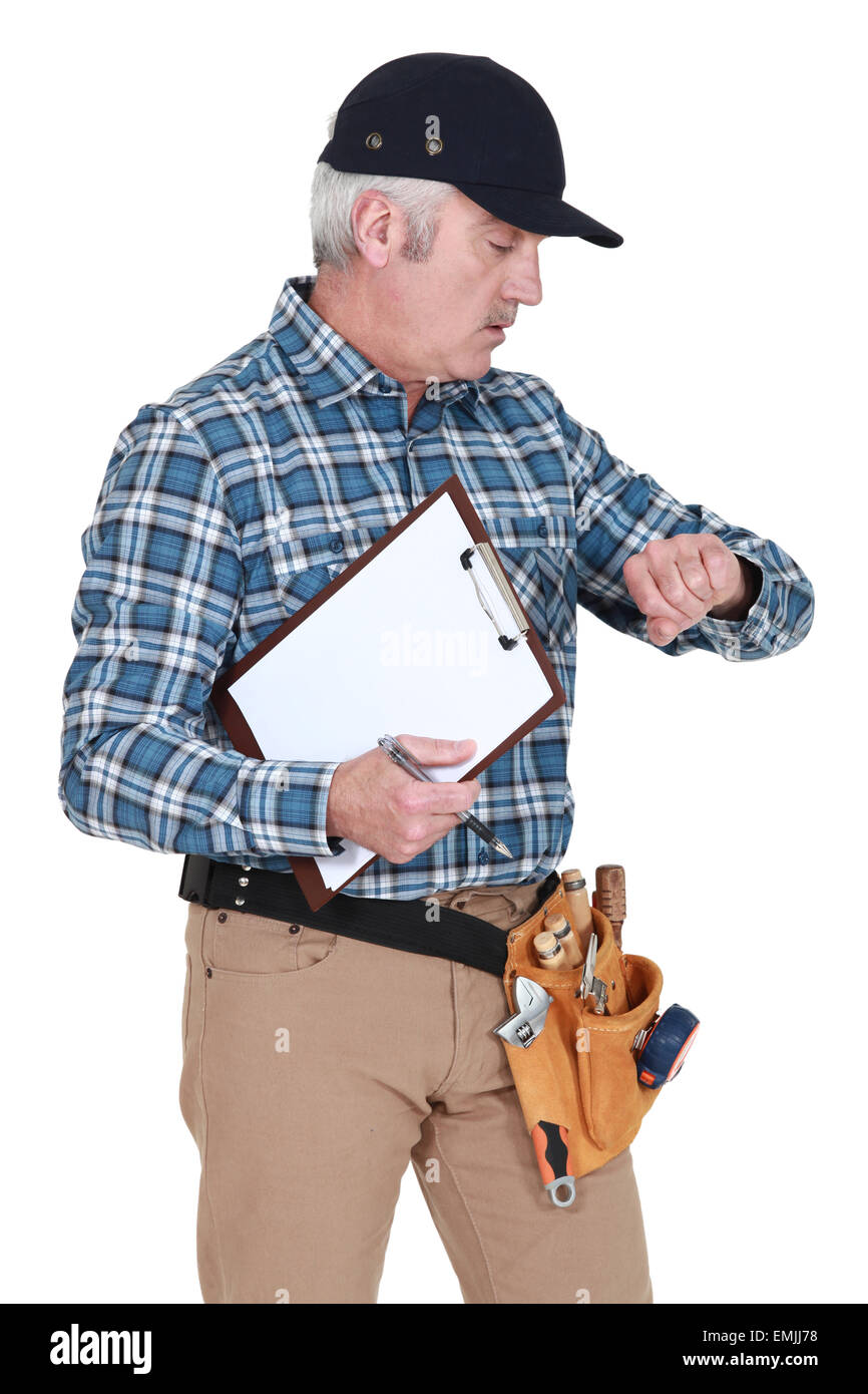 A handyman looking at his watch Stock Photo - Alamy