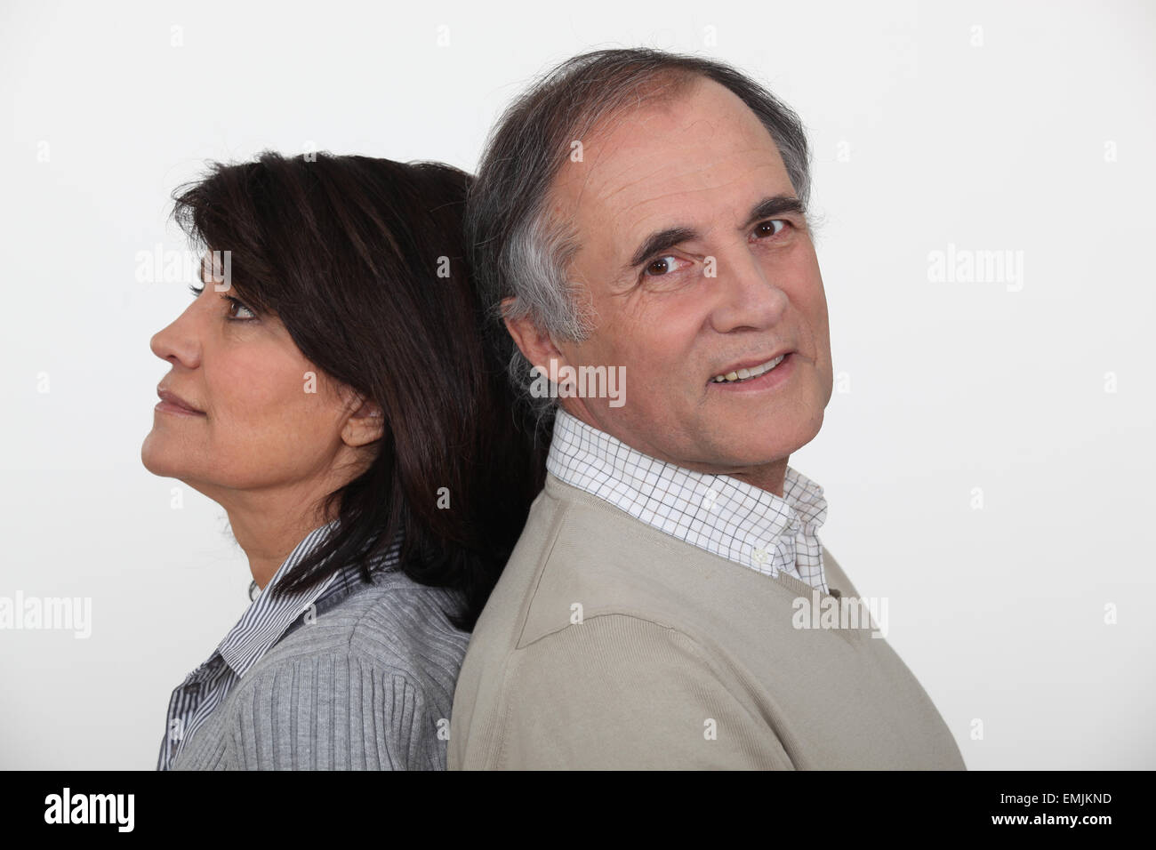 Husband and wife standing back to back Stock Photo - Alamy