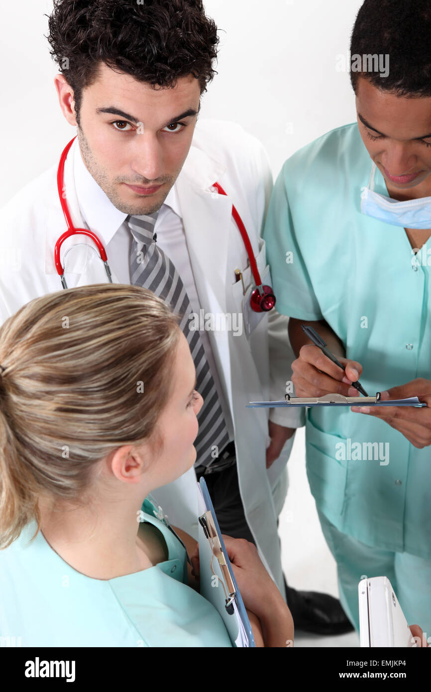 Three staff members discussing on hi-res stock photography and images ...