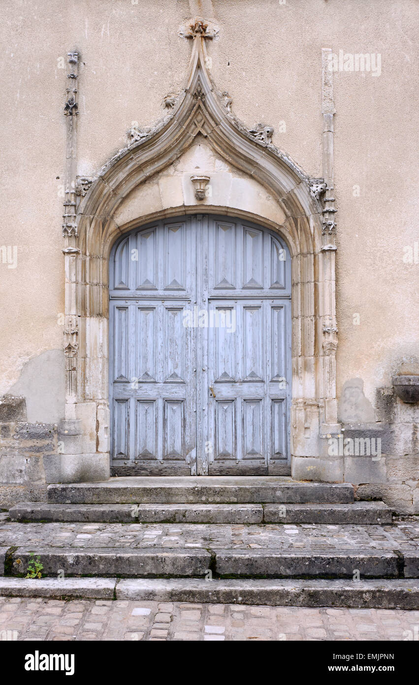 Stone portal and a wooden door to the medieval church in France Stock ...