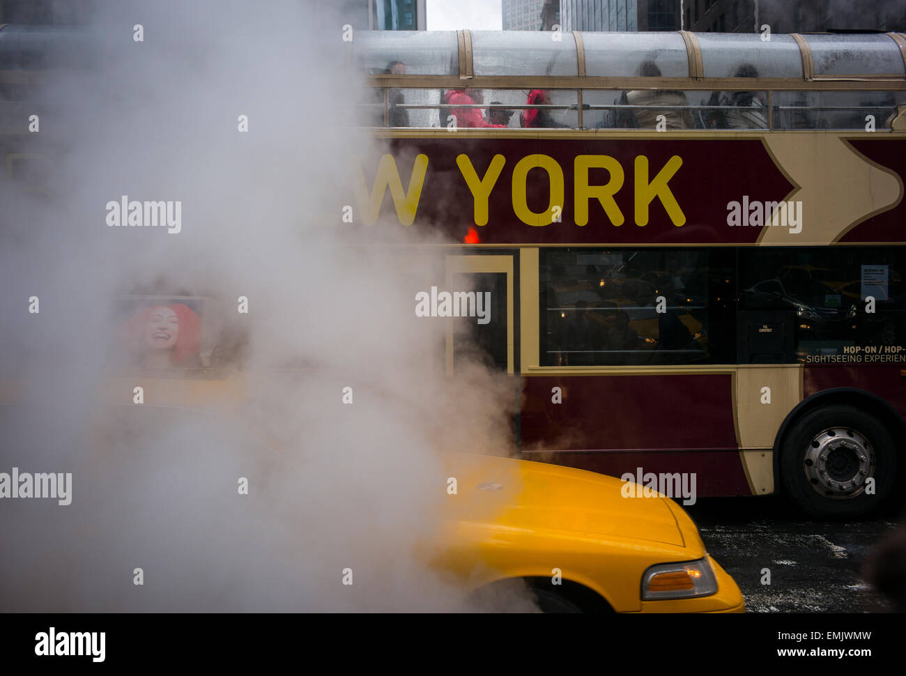 Steam rises from an underground pipe as a tour bus crosses an ...