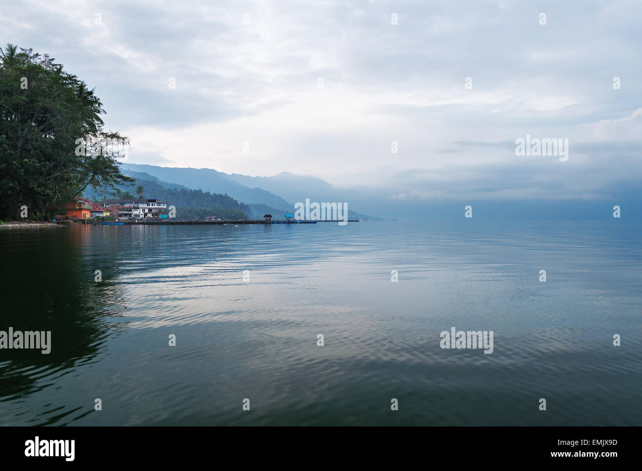 Lake Maninjau in the early morning. Lake Maninjau (Danau Maninjau) is a ...