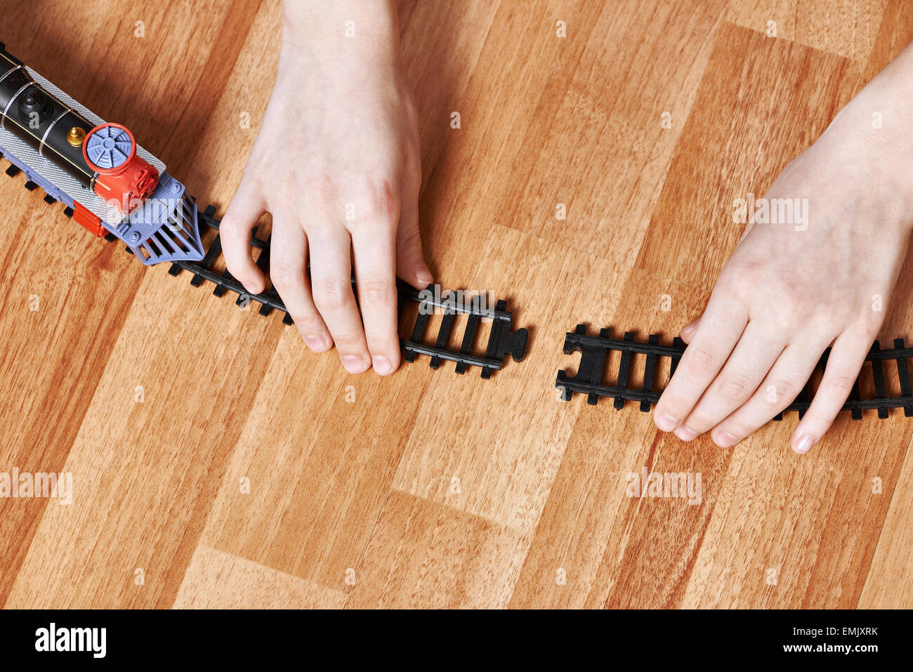 Assembling the railway. Connect rails Stock Photo - Alamy