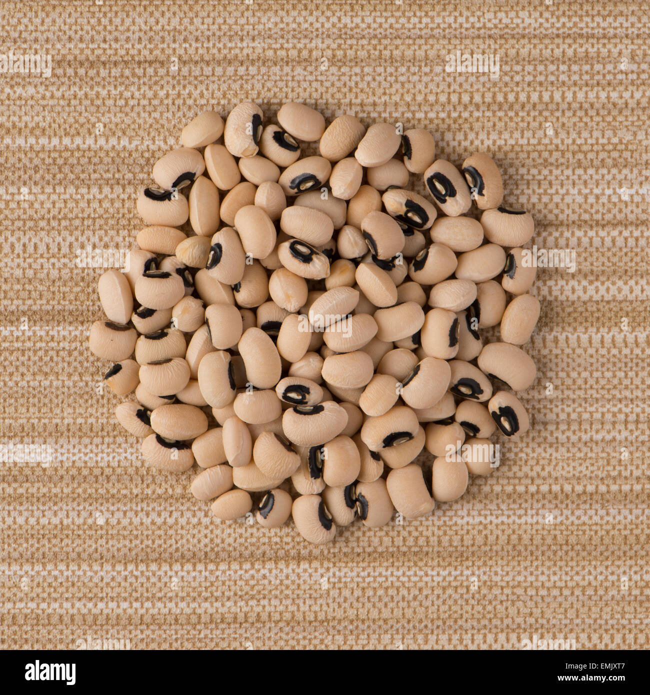 Top view of circle of white beans against beige vinyl background Stock ...