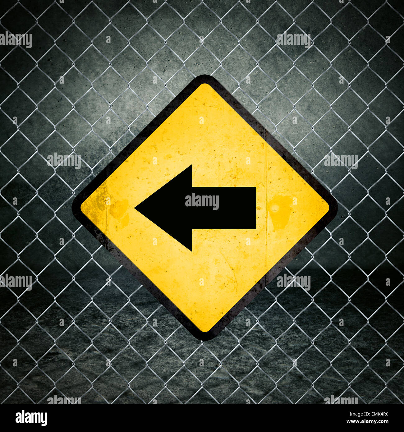 Left Direction Grunge Yellow Warning Sign on Chainlink Fence of ...