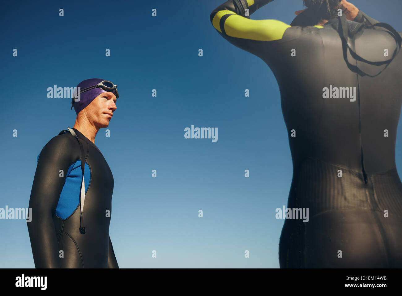 Outdoor shot of a determined male triathlete wearing wetsuit ready for ...