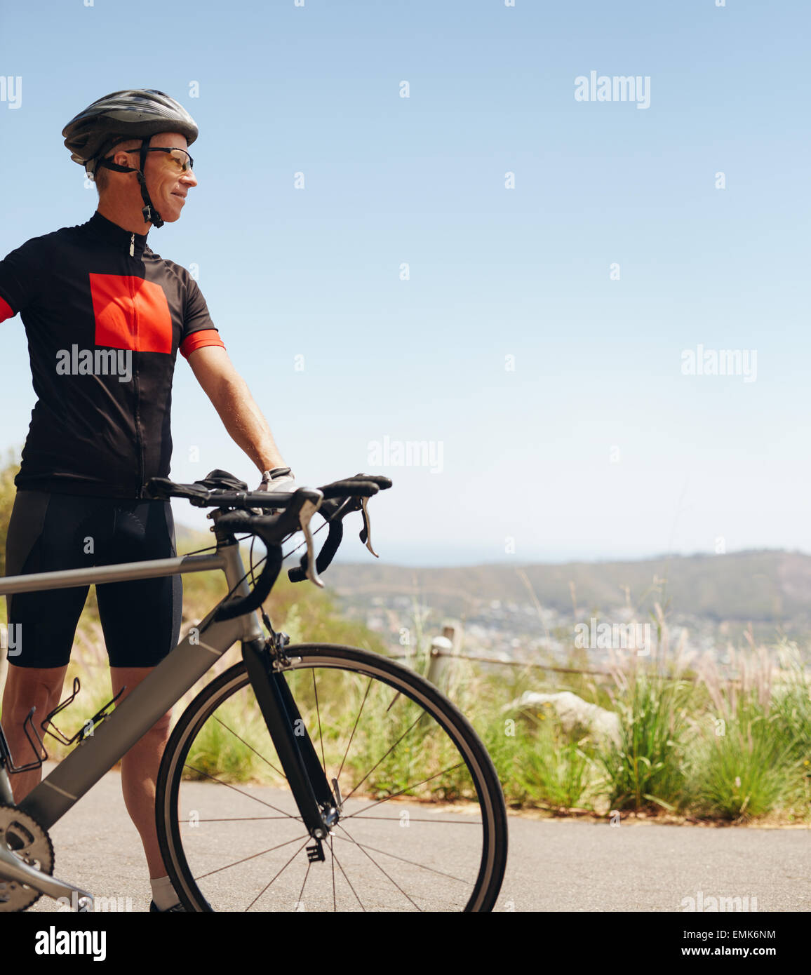 Image of happy male cyclist with his bike on the country side. Young ...