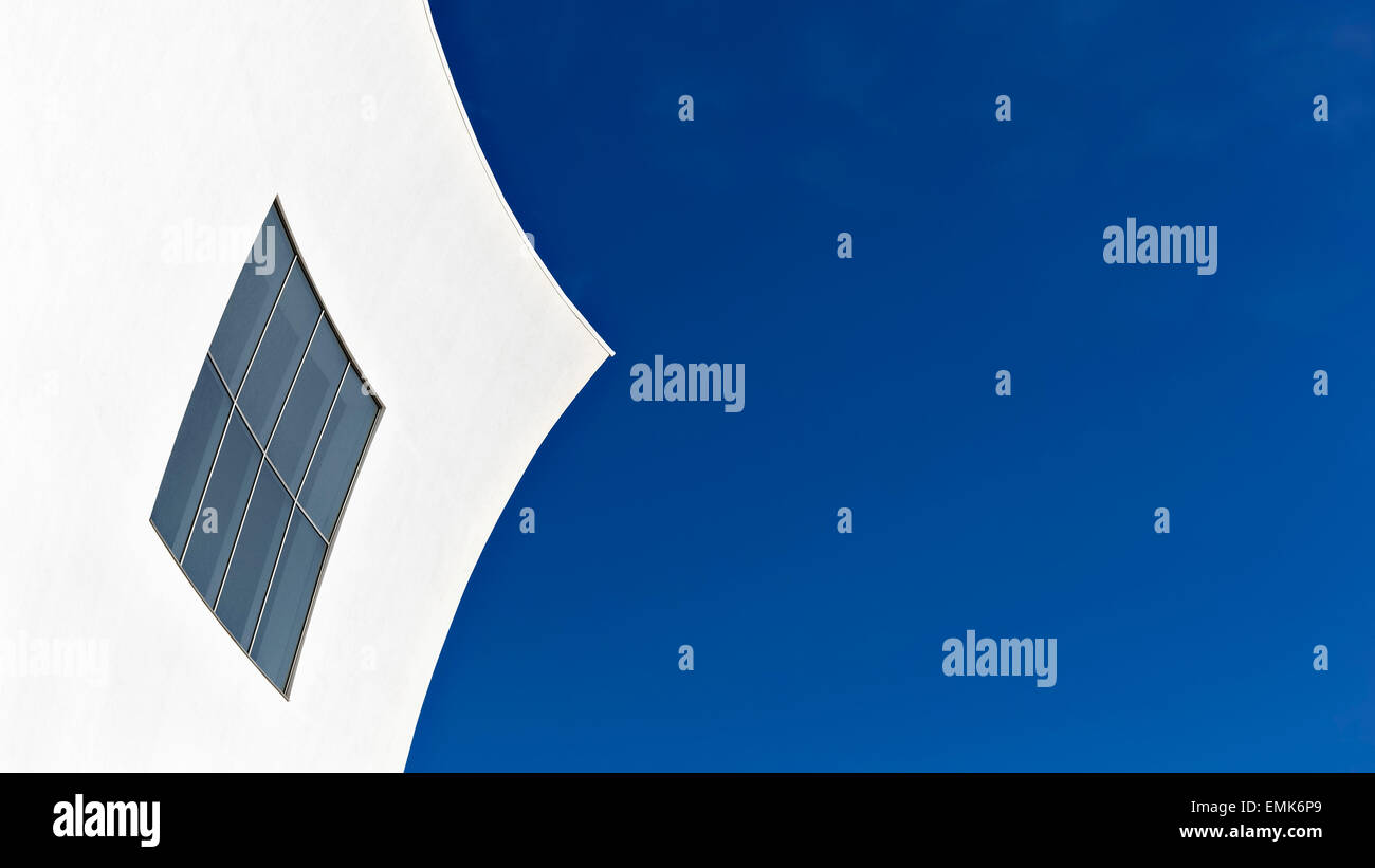 White concave facade with window against a blue sky, detail, Auditorium ...