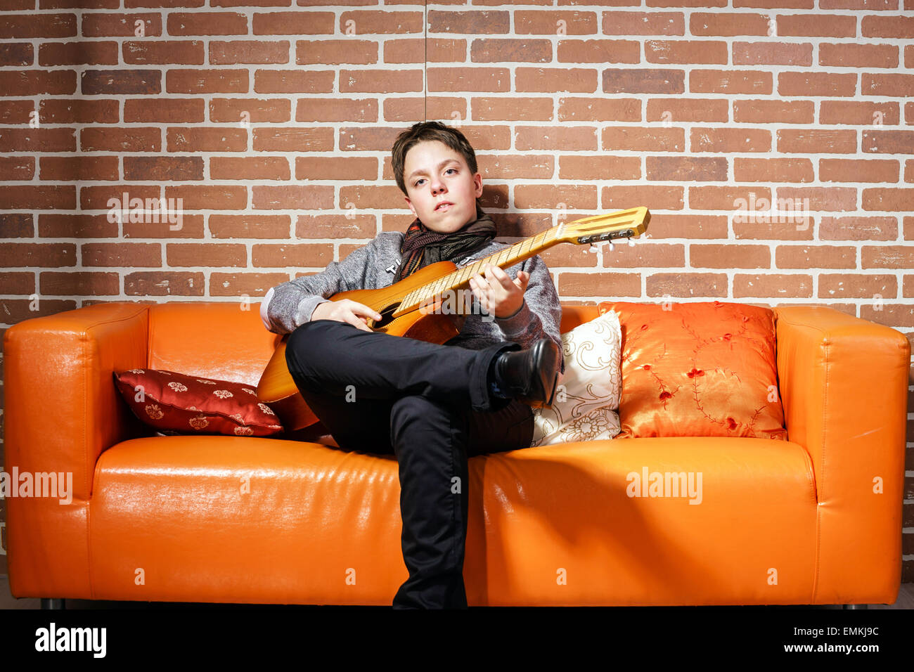 Young teenage musician posing with guitar, studio portrait Stock Photo ...