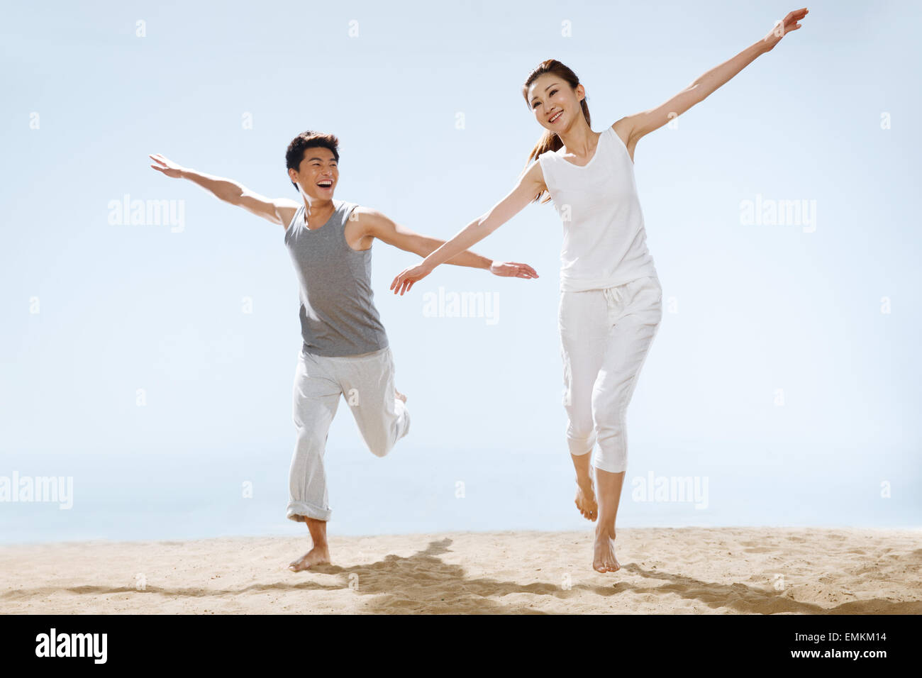 Romantic couples running on the beach Stock Photo - Alamy