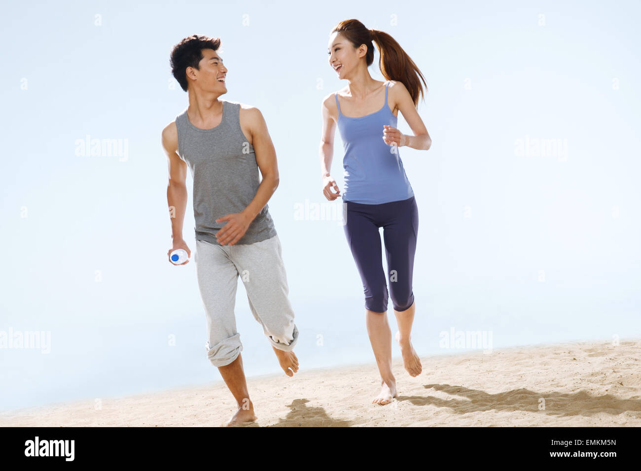 Romantic couples running on the beach Stock Photo - Alamy