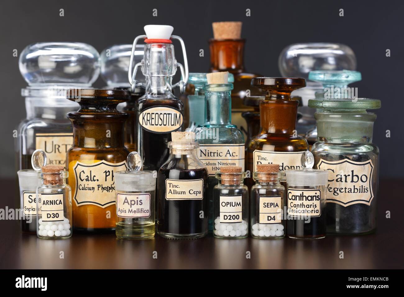 Various pharmacy bottles of homeopathic medicine on dark background ...