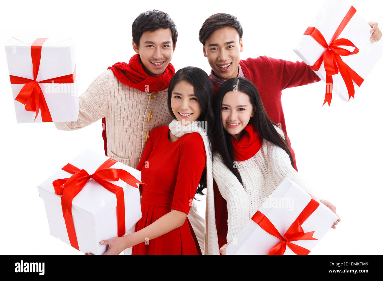 Four stylish young people take a gift box Stock Photo - Alamy