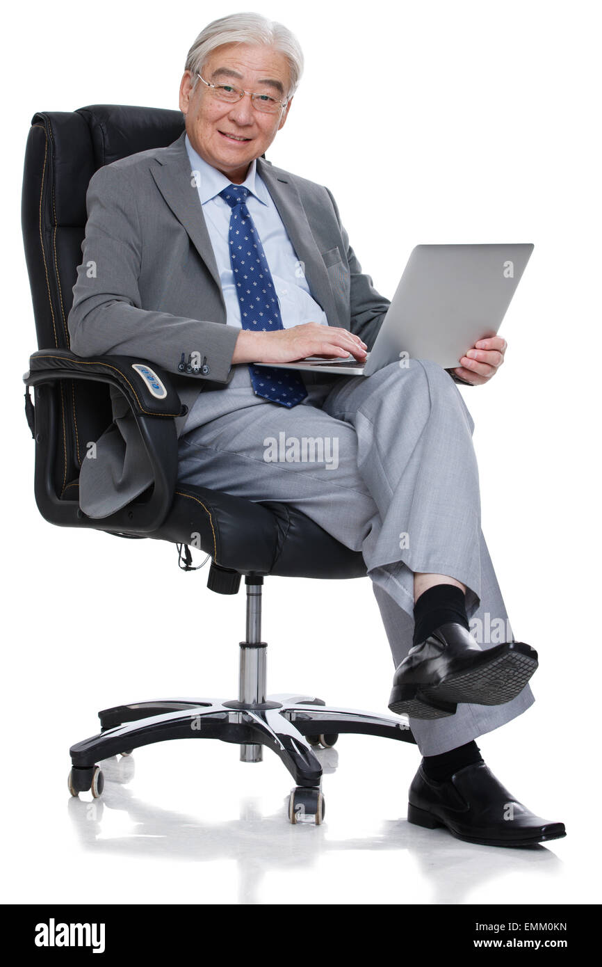 Sitting in office using laptop Cut Out Stock Images & Pictures - Alamy
