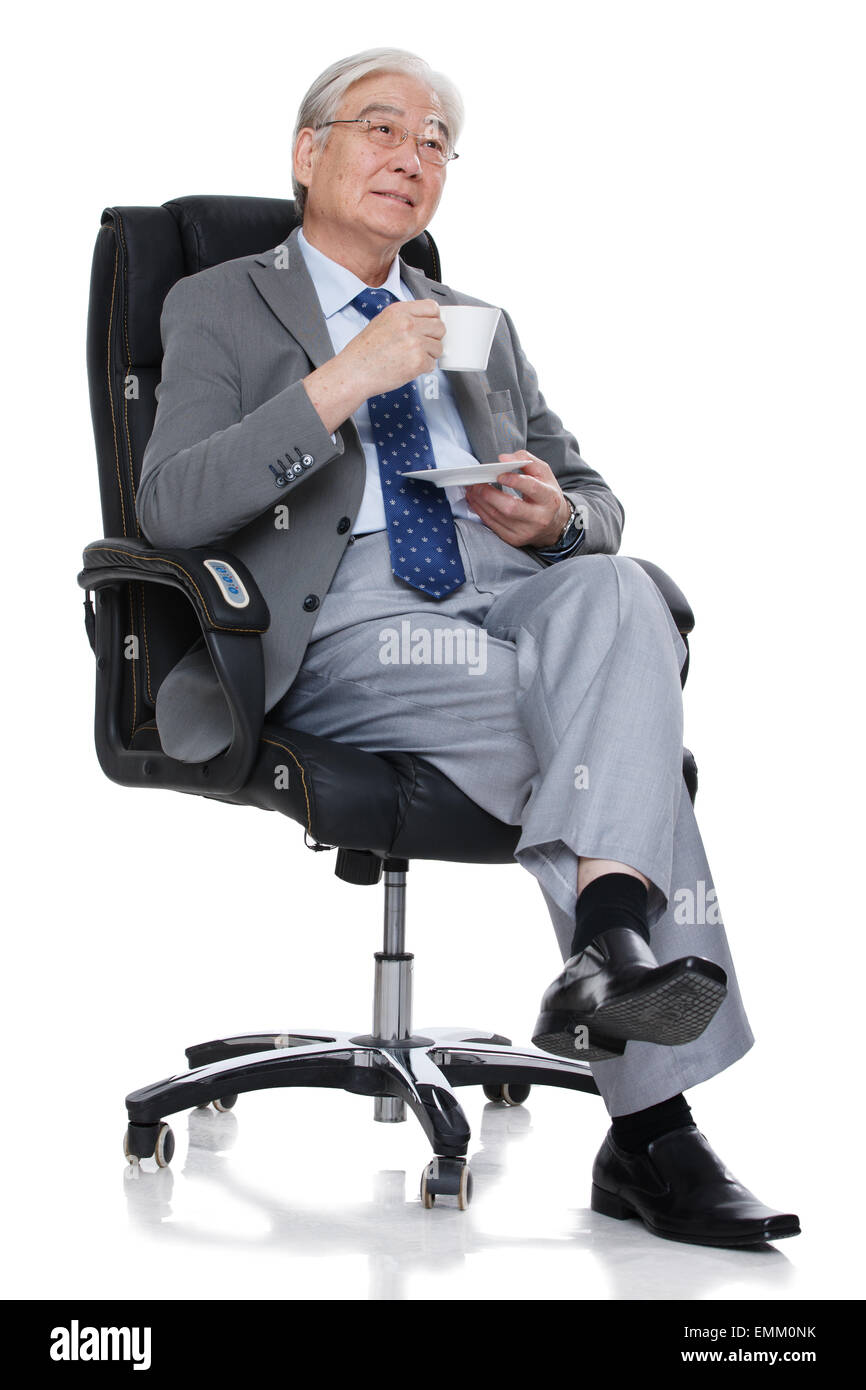 A sitting in the boss's chair to drink Coffee old man Stock Photo - Alamy