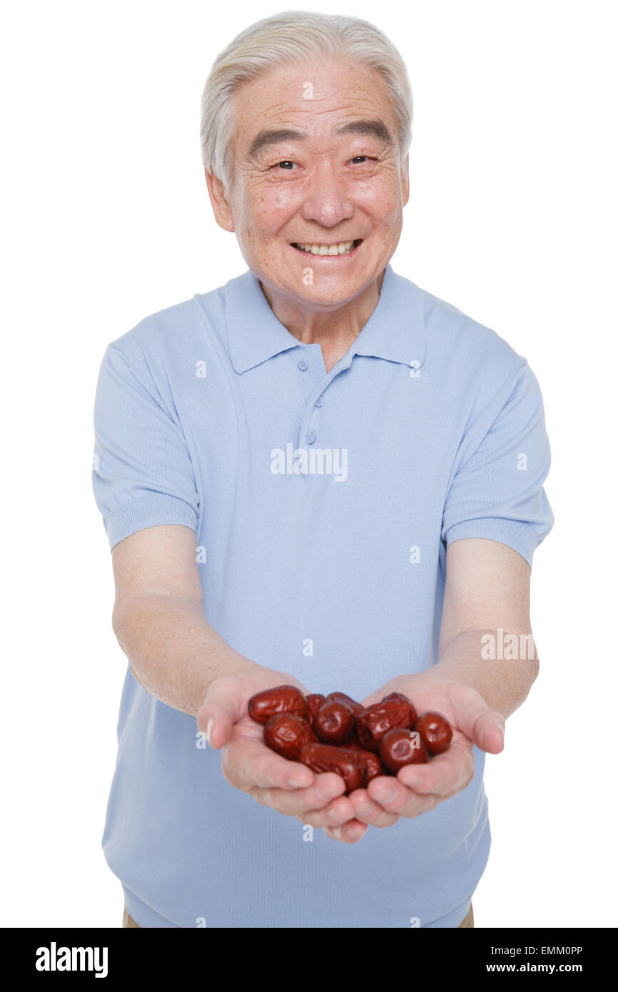 Old man eating fruit hi-res stock photography and images - Alamy