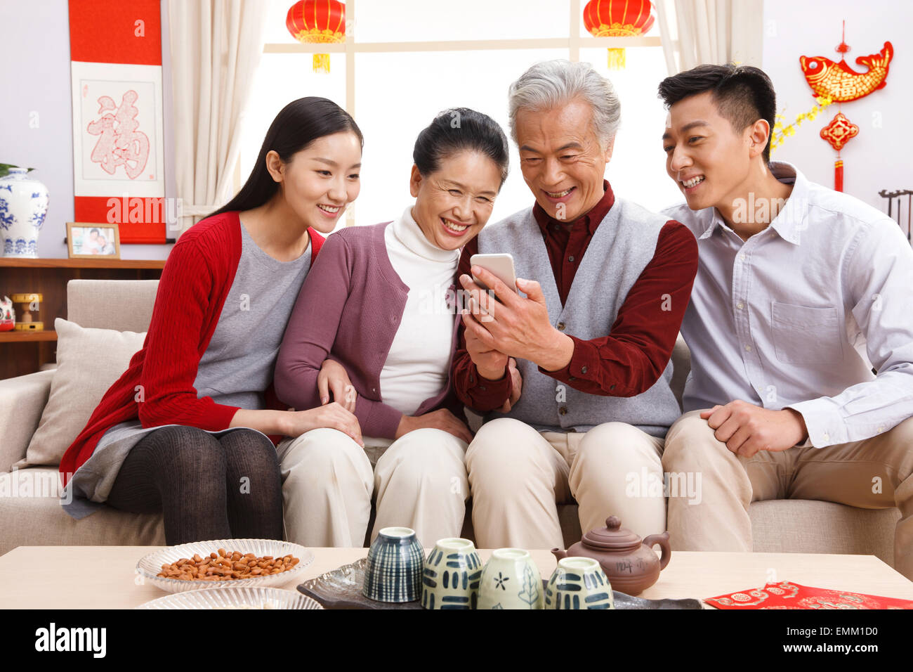 Happy family use mobile phone Stock Photo - Alamy