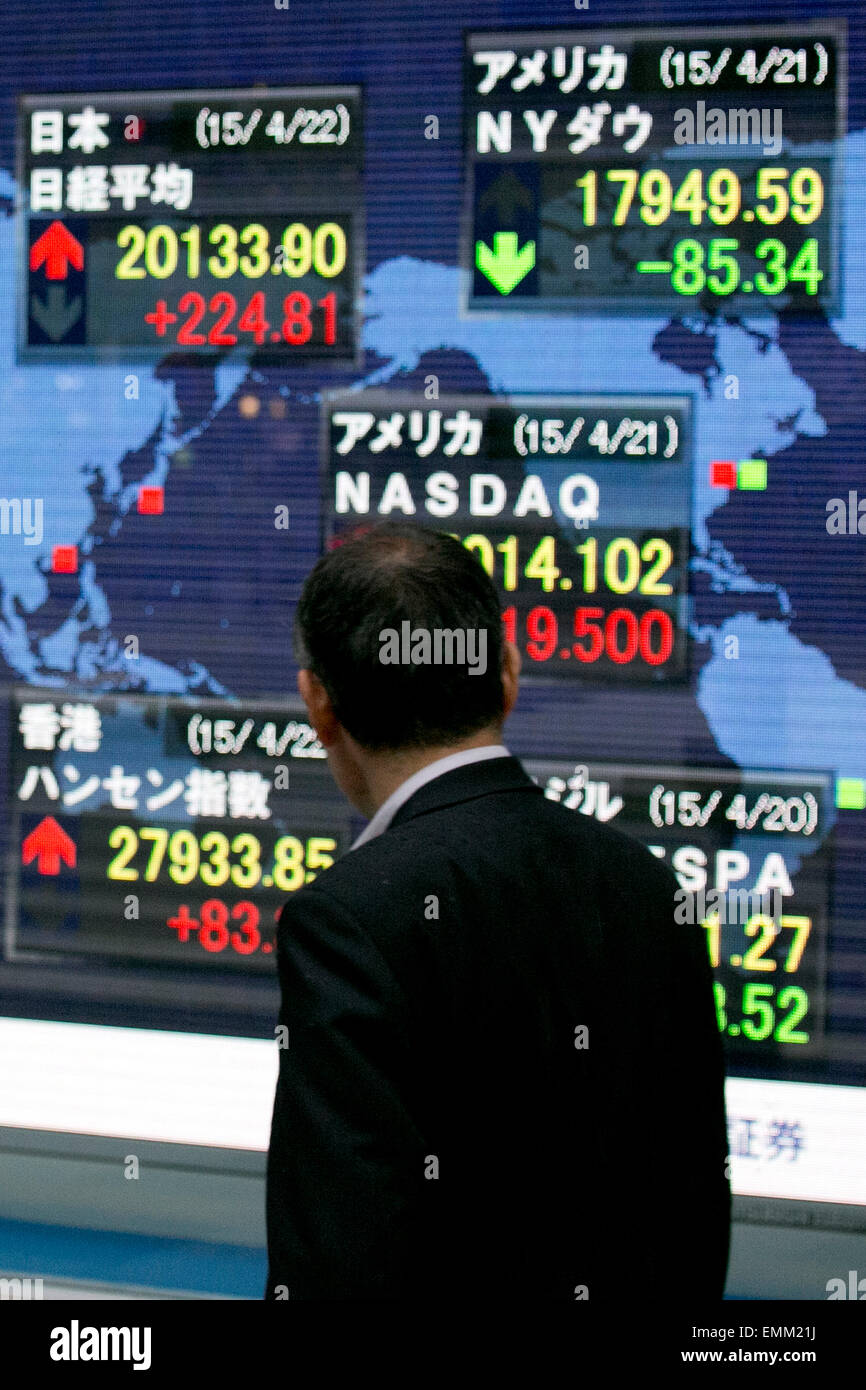 Tokyo, Japan. 22nd April, 2015. A man looks at the stock market ...