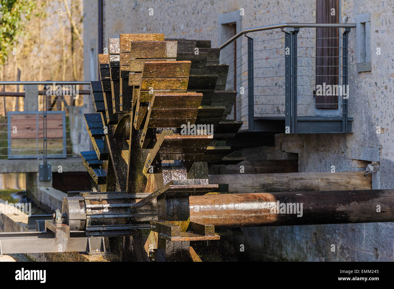 Series of three wheeled wooden mill renovated Stock Photo - Alamy