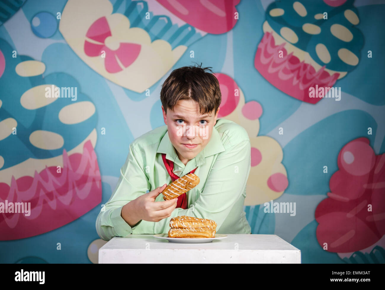Funny teenage boy eating sweet cakes, hungry and candy man Stock Photo ...