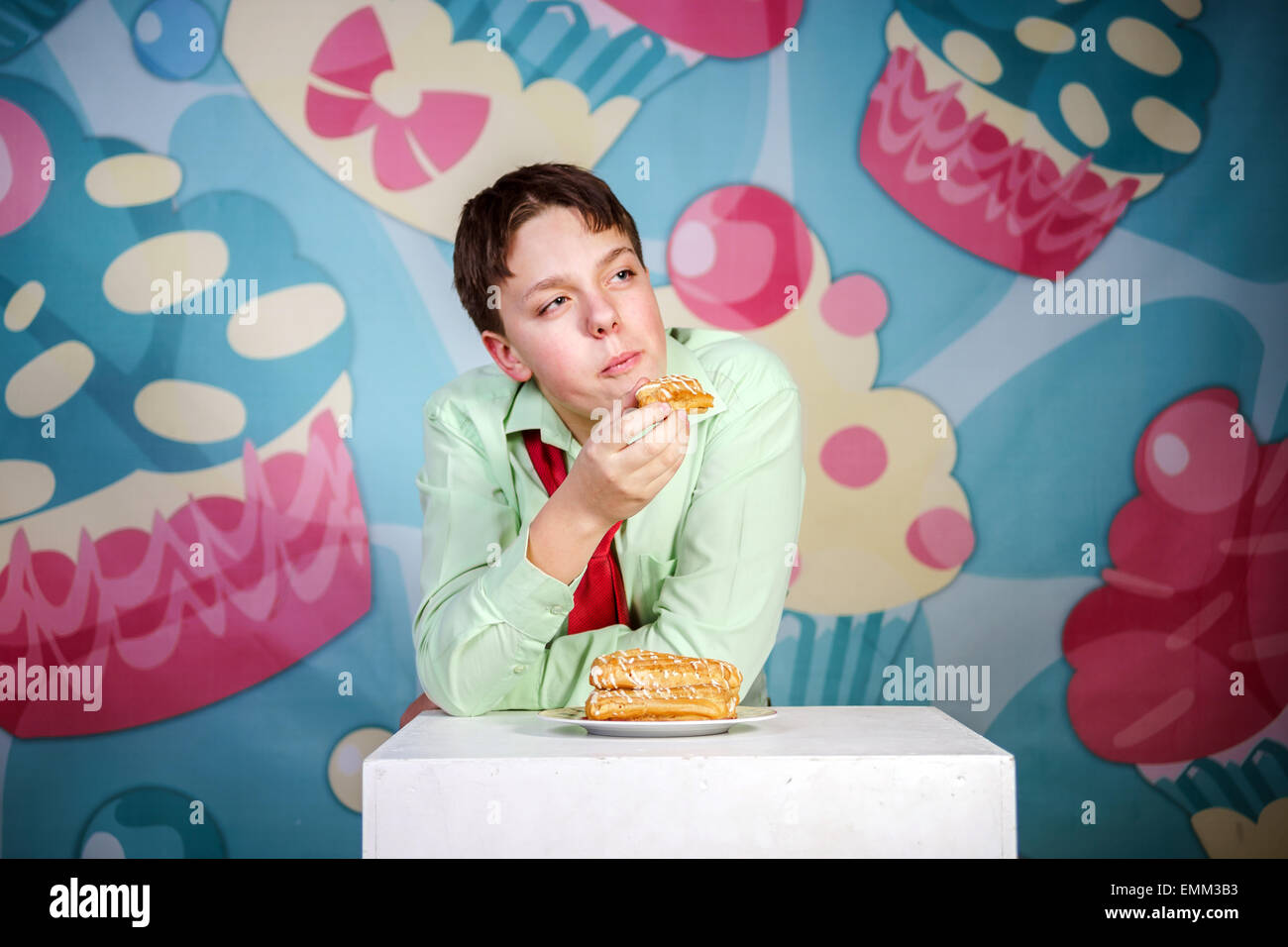 Funny teenage boy eating sweet cakes, hungry and candy man Stock Photo ...